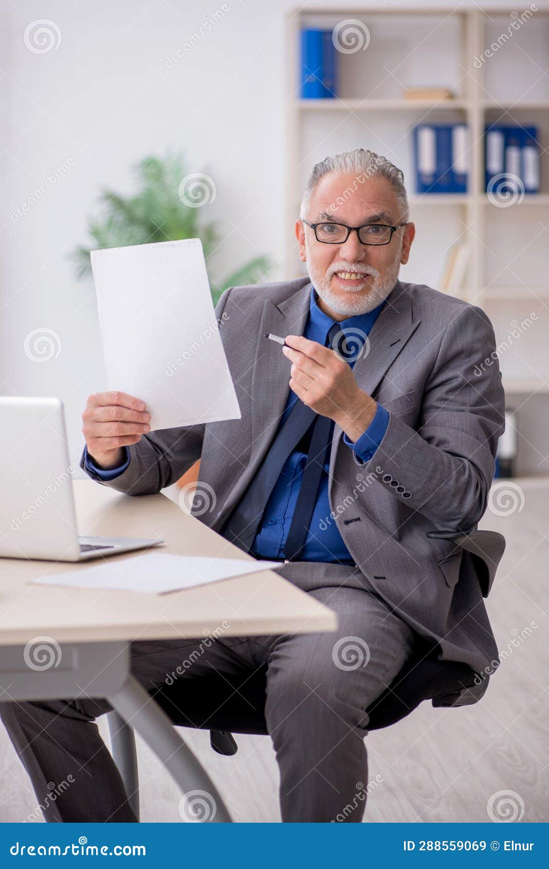Old Male Employee Reading Paper at Workplace Stock Image - Image of ...