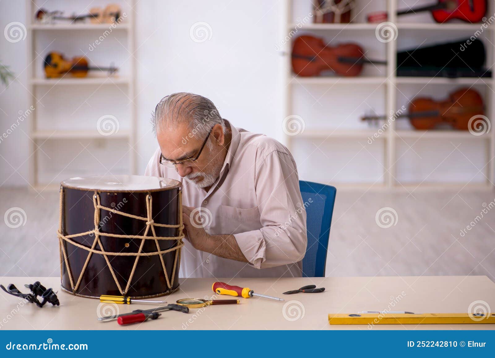 Old Male Repairman Repairing Musical Instruments at Workshop Stock ...