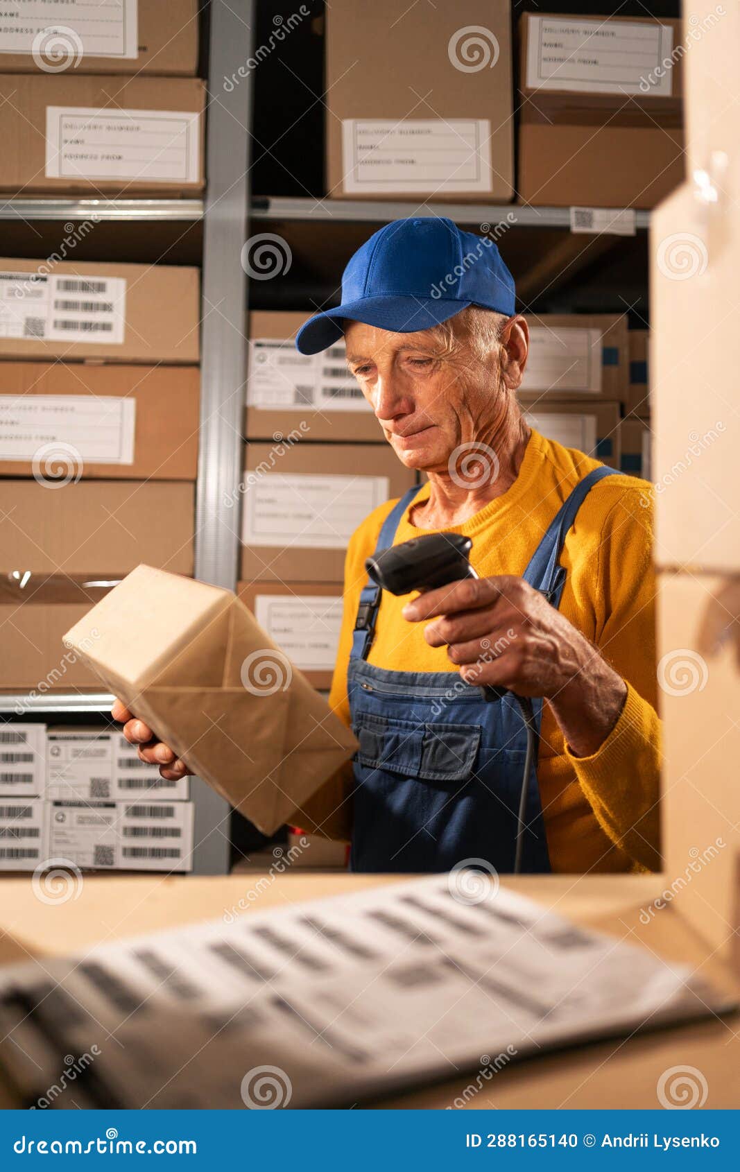 Old Male Warehouse Worker Scans Cardboard Box with Barcode Scanner ...