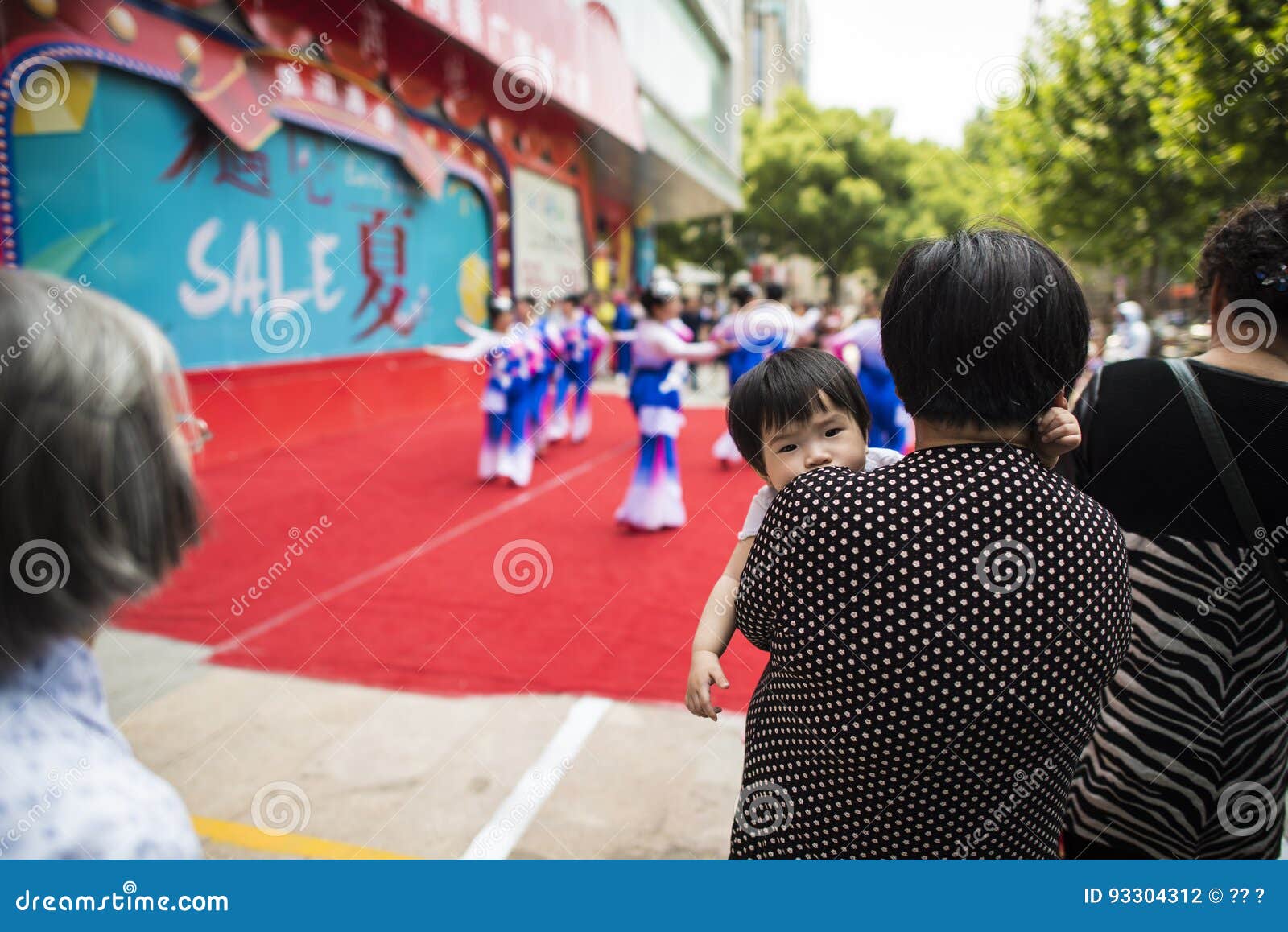 An Old Man with a Baby Watching a Performance Editorial Photography ...