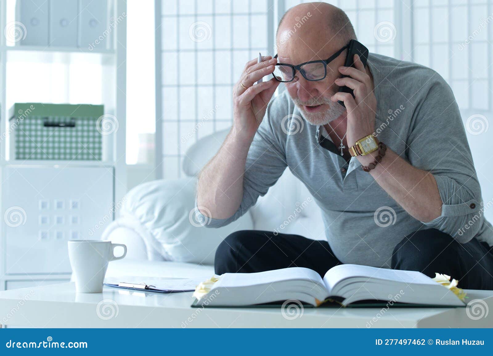 Old Man with Book Talking on Phone and Taking Notes Stock Photo - Image ...