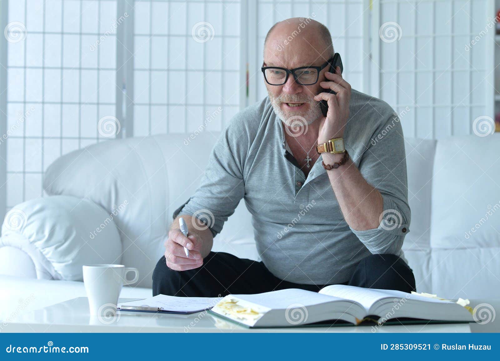 Old Man with Book Talking on Phone and Taking Notes Stock Image - Image ...