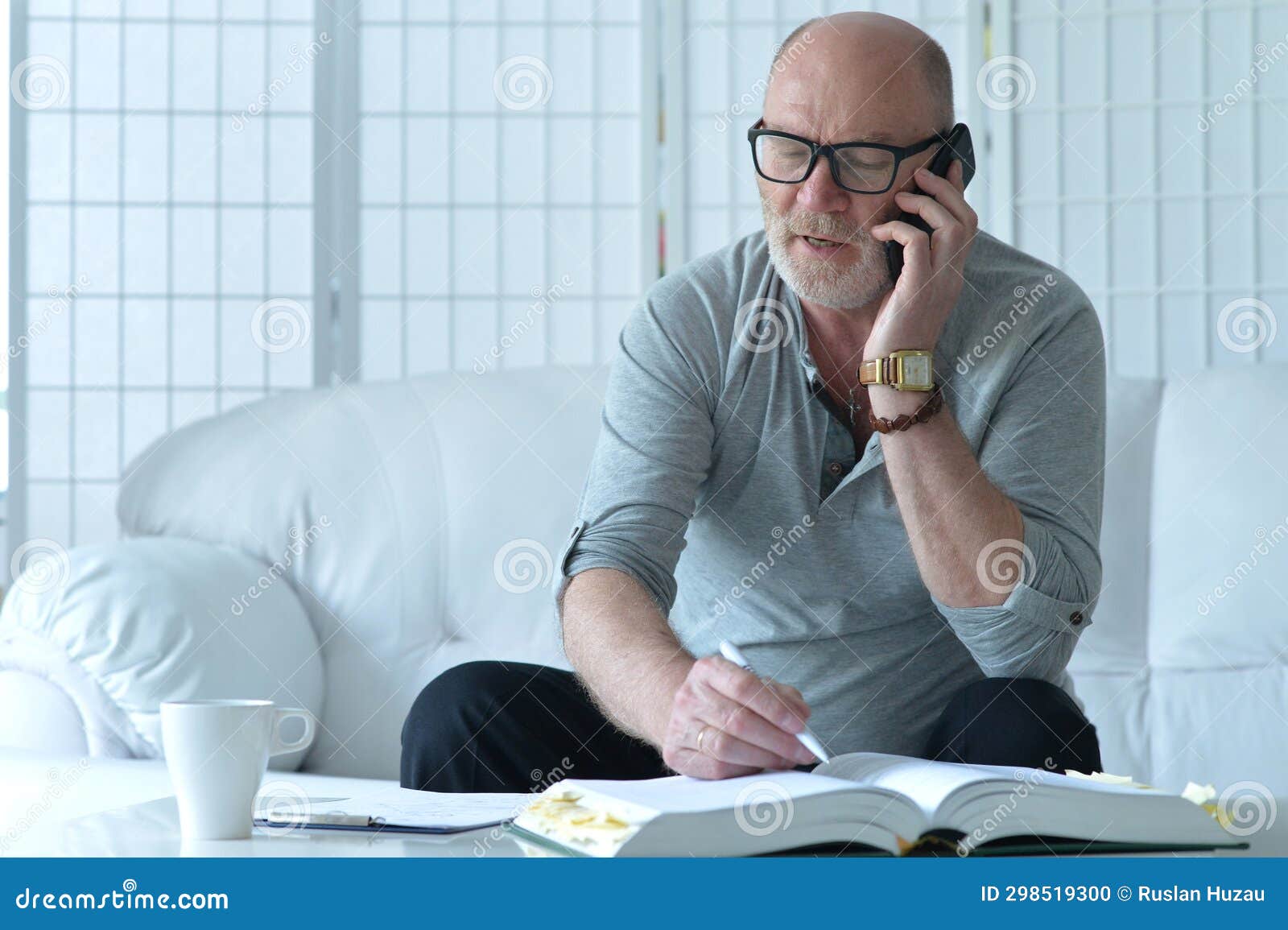 Old Man with Book Talking on Phone and Taking Notes Stock Photo - Image ...