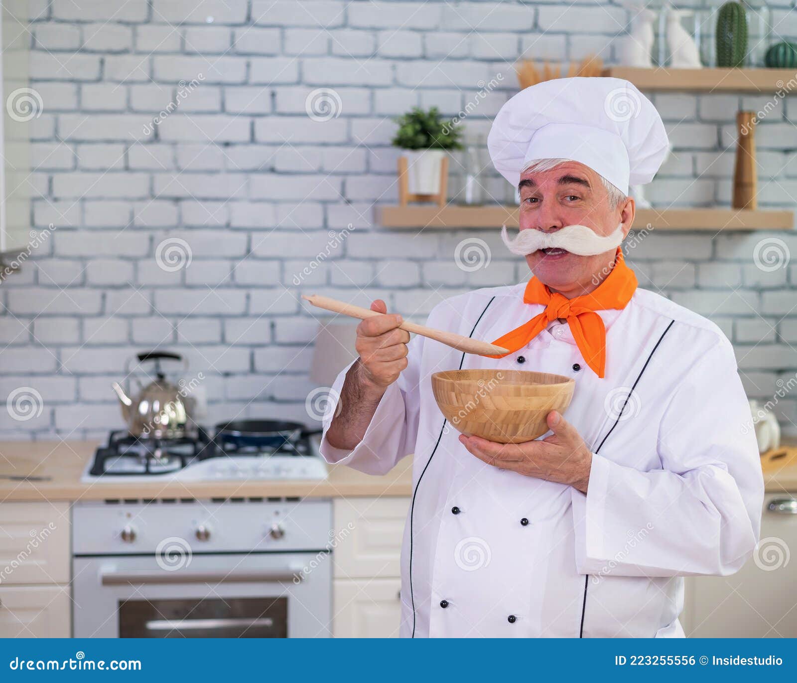 An Old Man with a Bushy Gray Mustache in a Chef S Hat is Cooking in the ...