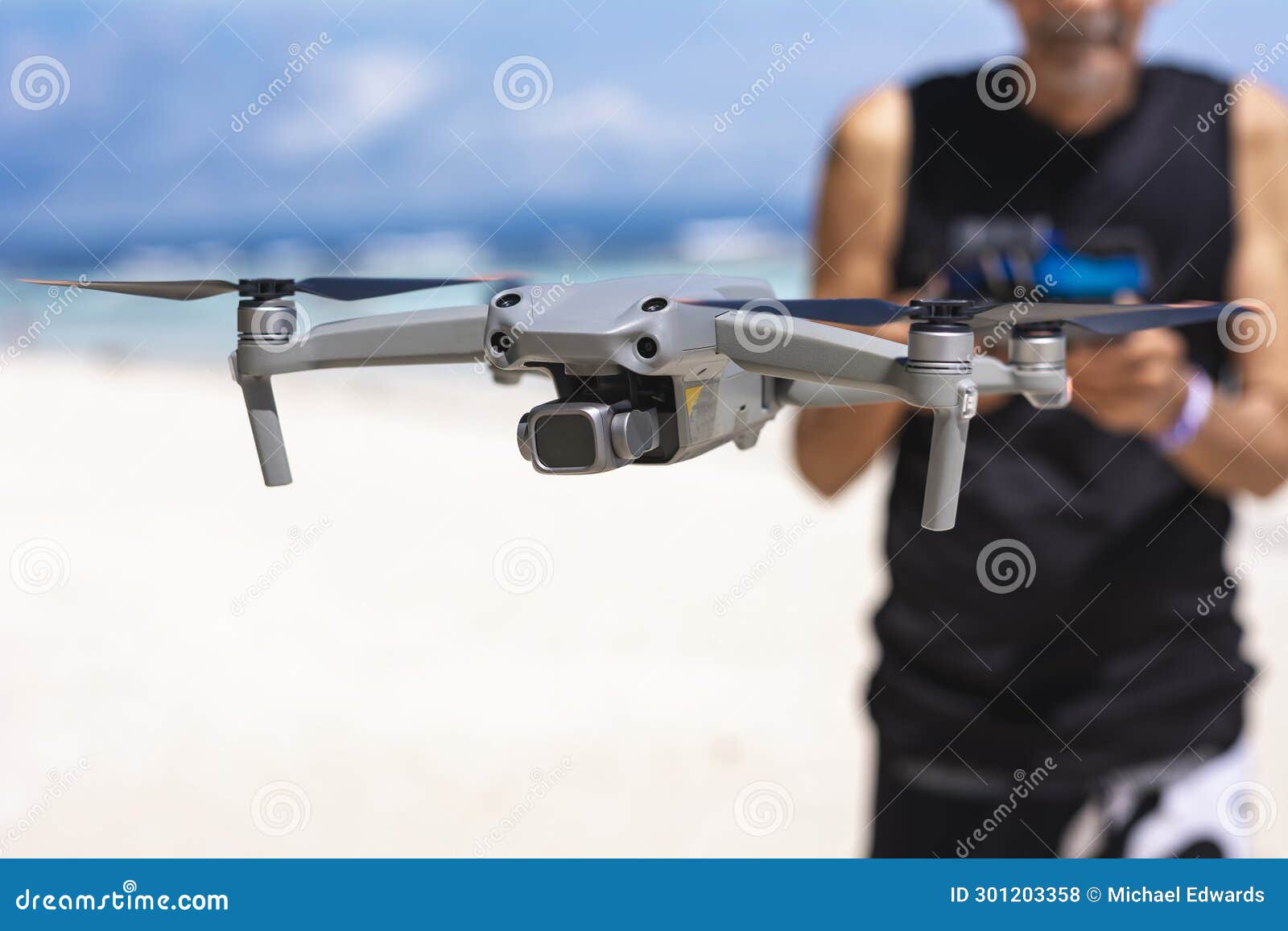 An Old Man Controlling a Small Drone at the Beach. a Hobbyist Drone ...