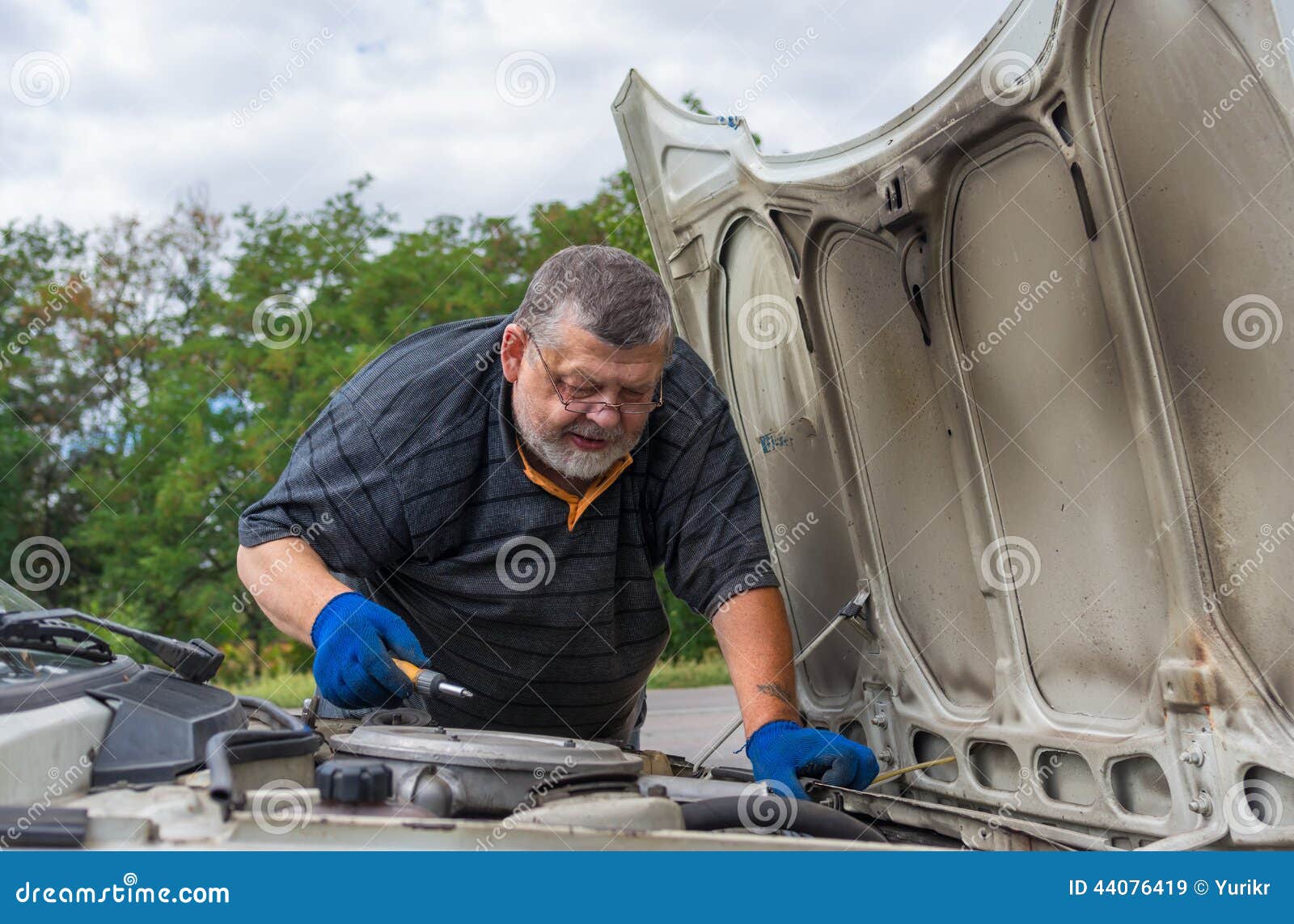 Old man doing car repair stock image. Image of handsome - 44076419