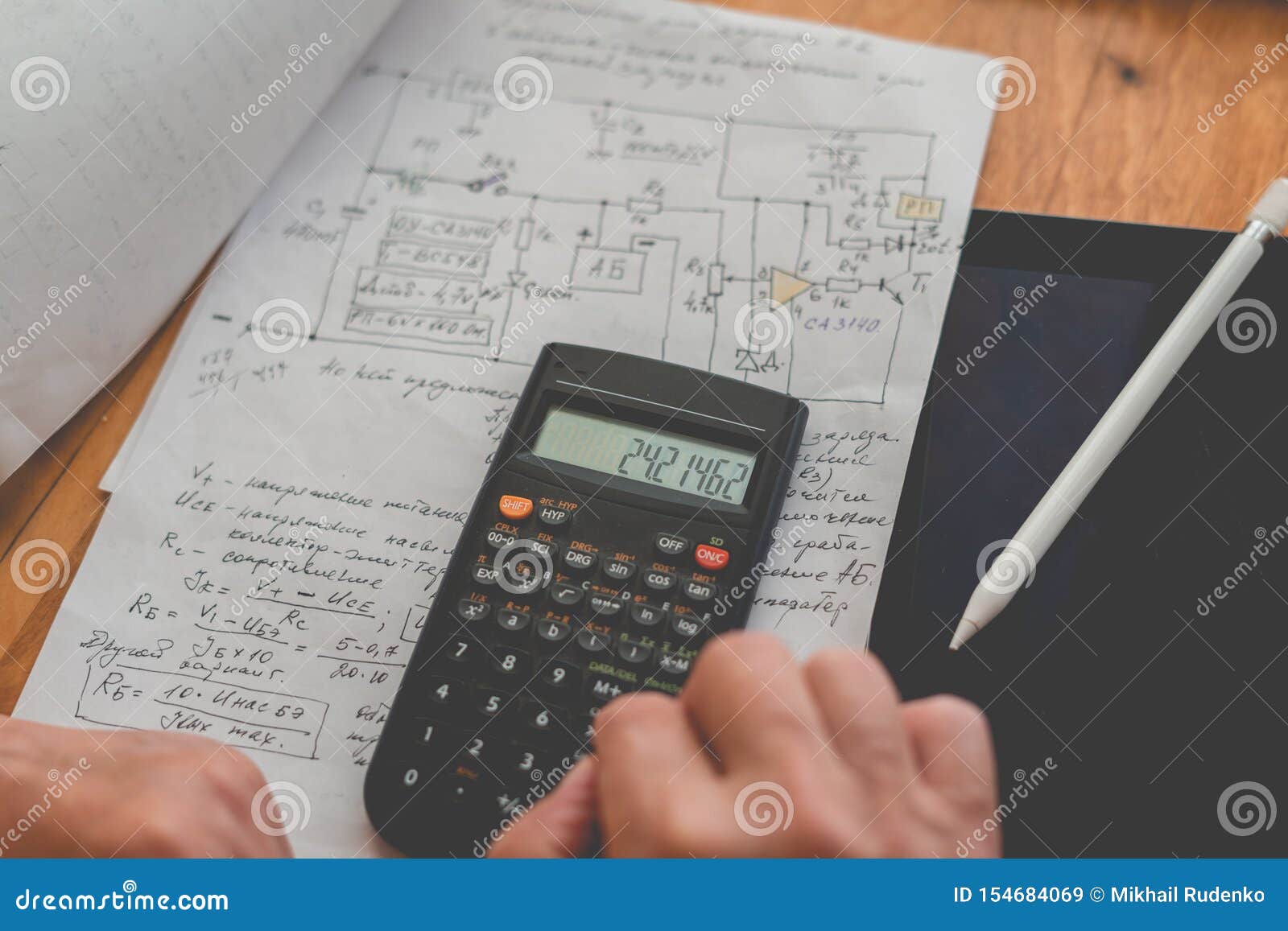 Old Man Doing Some Math Calculations Using Digital Calculator at His ...