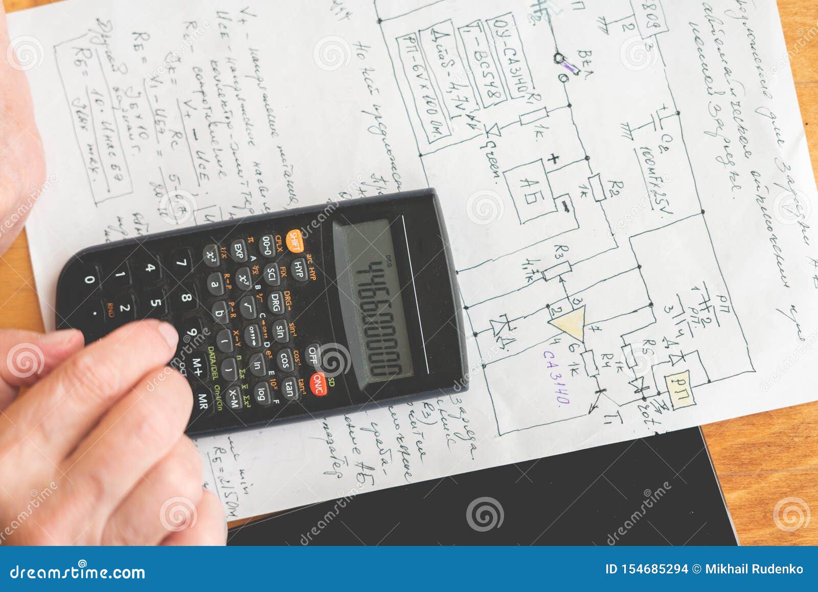 Old Man Doing Some Math Calculations Using Digital Calculator at His ...