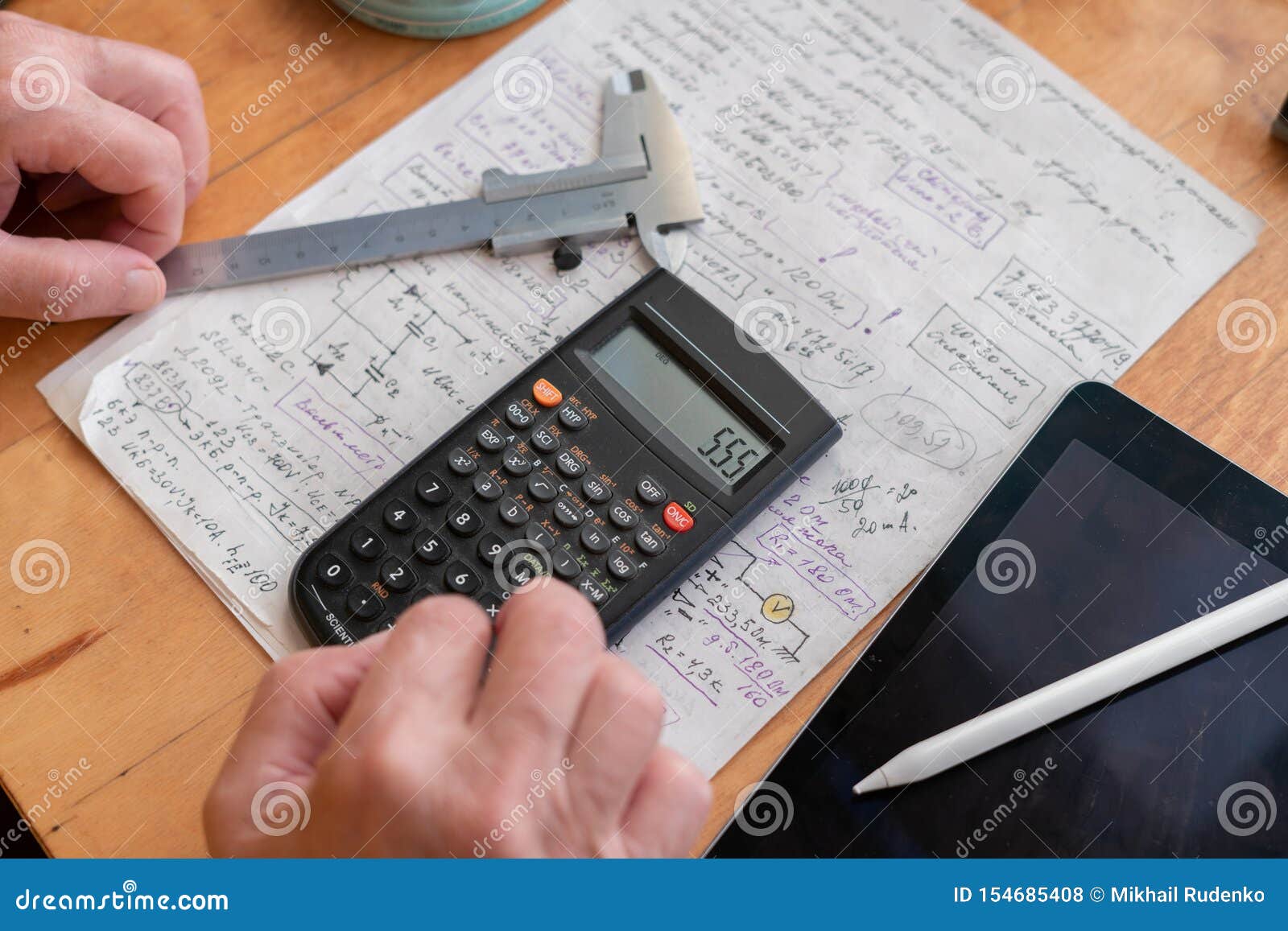 Old Man Doing Some Math Calculations Using Digital Calculator at His ...