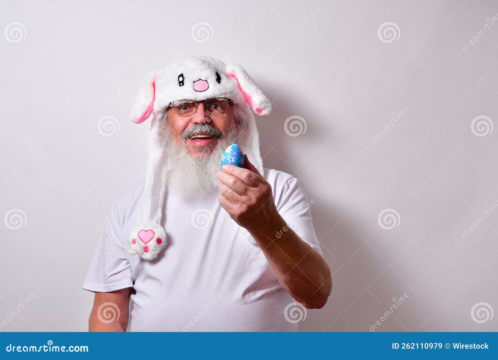 Old Man Dressed As an Easter Bunny Holdinga Decorated Egg Stock Image ...