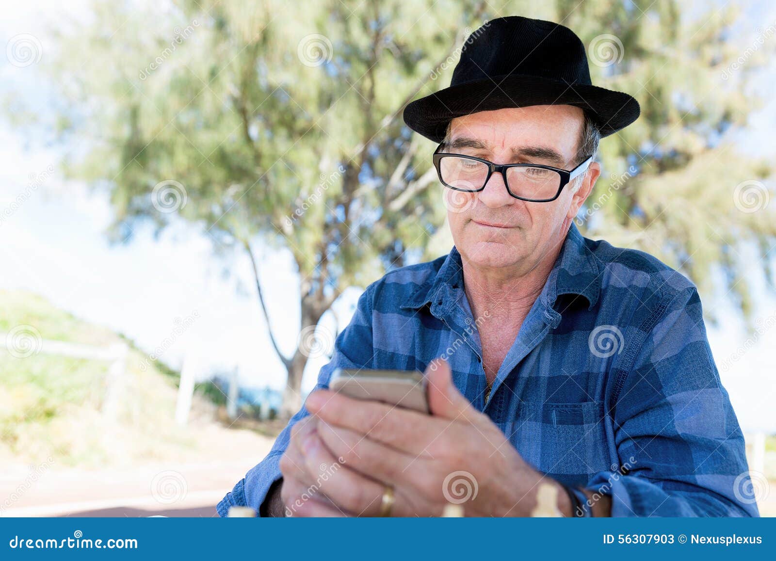 Old man with his mobile stock image. Image of mature - 56307903