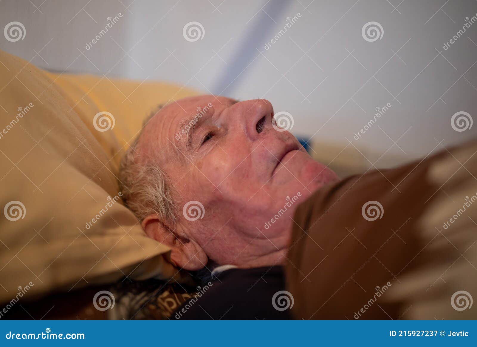Old man lying in bed stock image. Image of bedroom, senior - 215927237