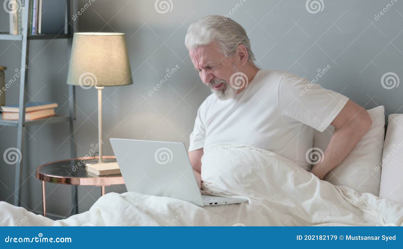 Old Man with Laptop Having Back Pain in Bed Stock Video - Video of ...
