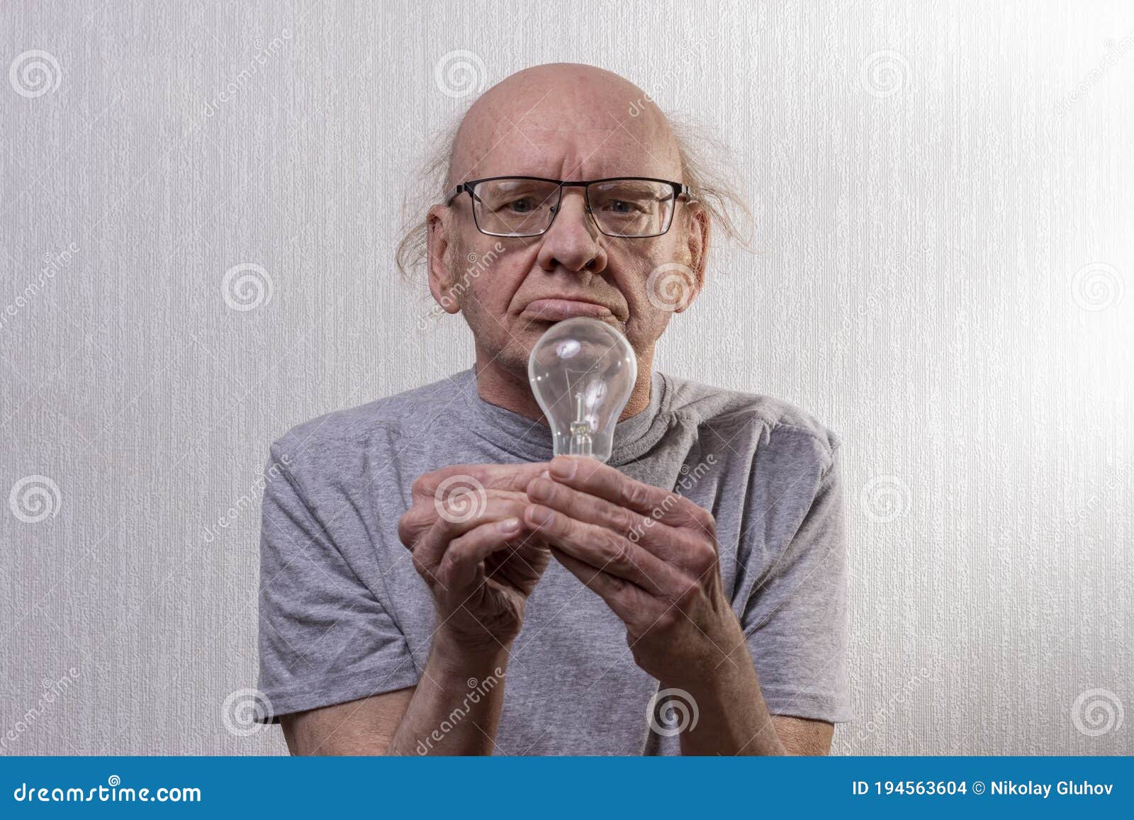 Old Man with Light Bulb. Portrait. Incandescent in Old Hands. Idea ...