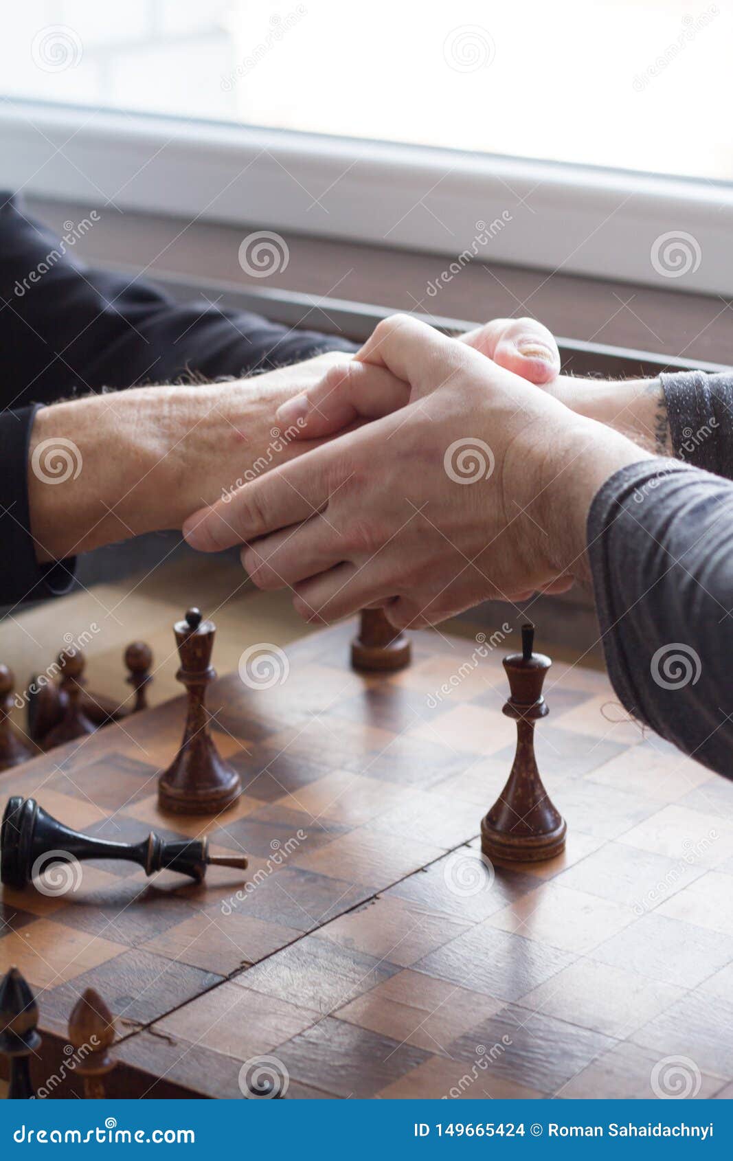 An Old Man Shakes Hands with an Opponent in a Game of Chess, he Lost ...