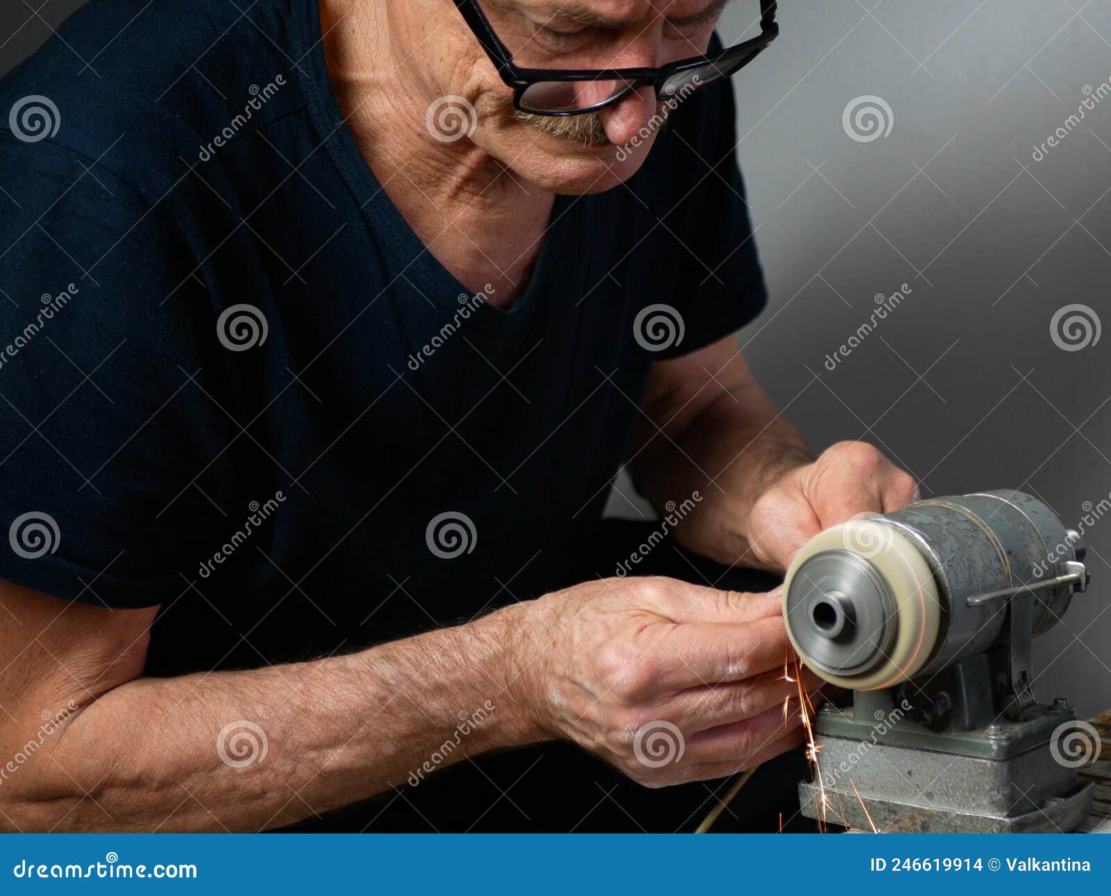 Old Man is Sharpening a Tool Using Electrical Grinding Machine Stock ...