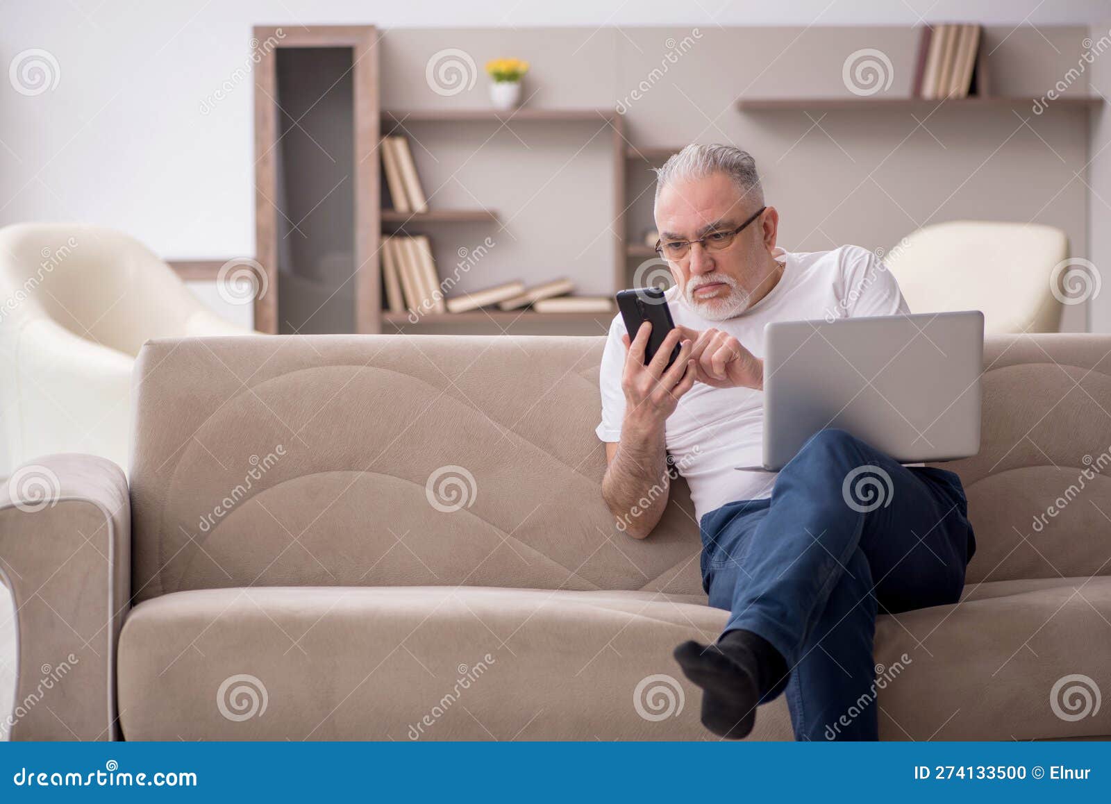 Old man sitting at home stock photo. Image of mobile - 274133500