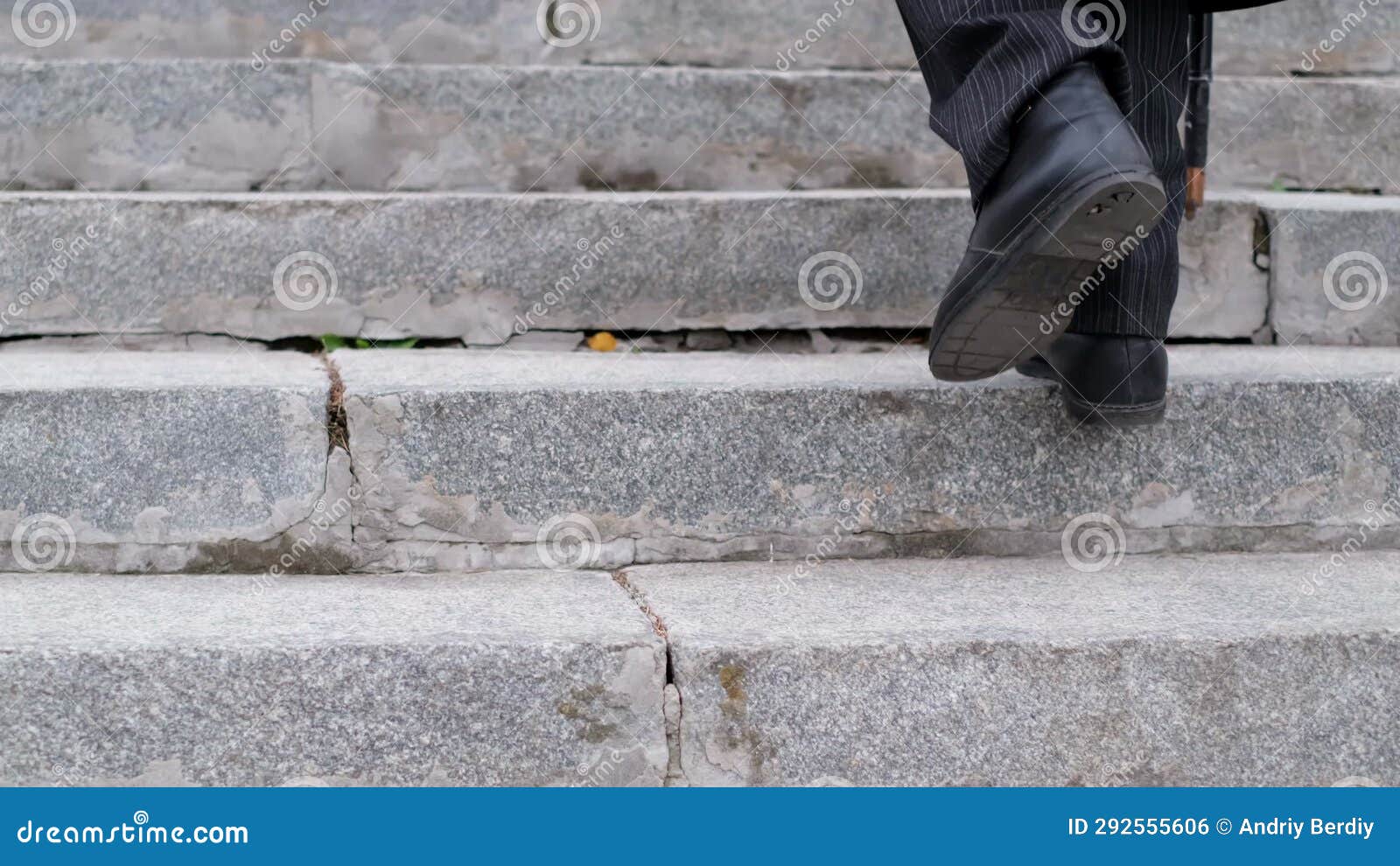 An Old Man with a Stick in His Hands Climbs the Stairs To the Top ...