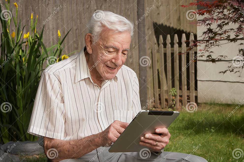 Old man on tablet computer stock photo. Image of joyful - 25013650
