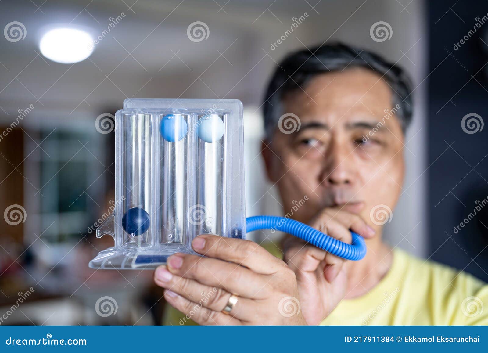 Old Man Uses a Tri-ball Incentive Spirometer for Check His Lung ...