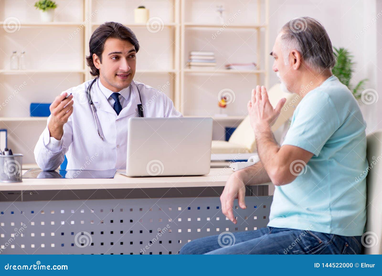 The Old Man Visiting Young Male Doctor Stock Photo - Image of medicine ...