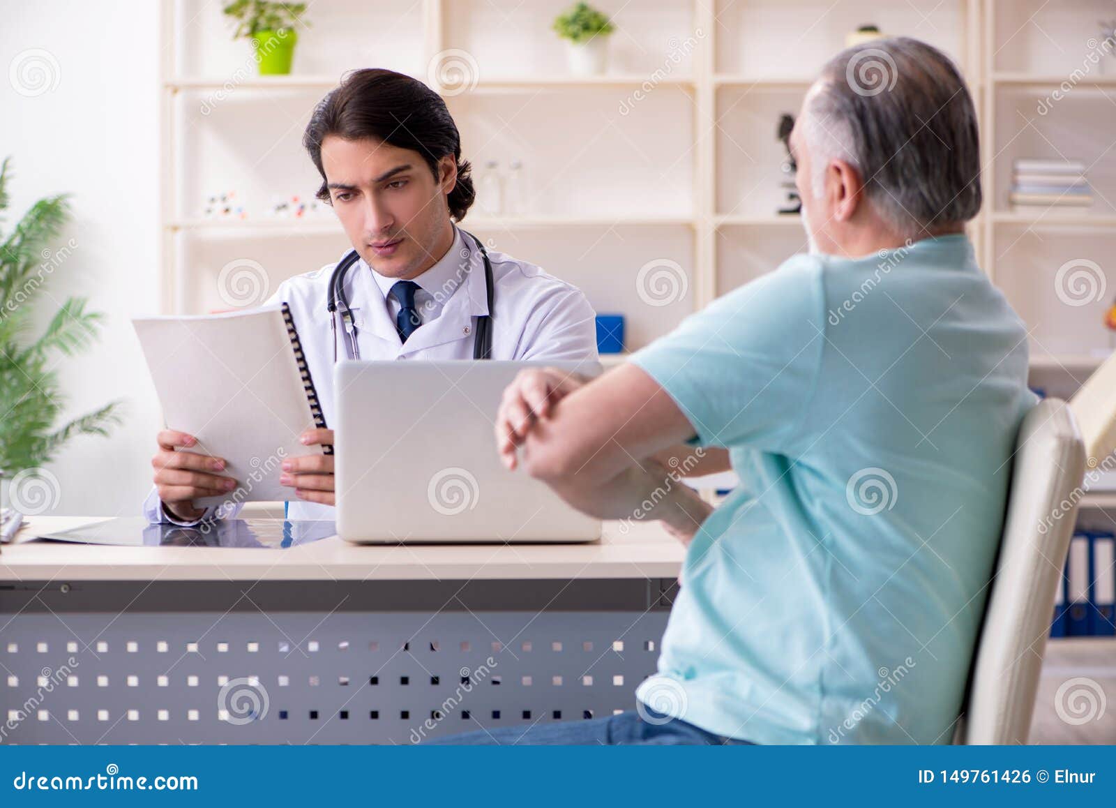 Old Man Visiting Young Male Doctor Stock Photo - Image of checkup ...