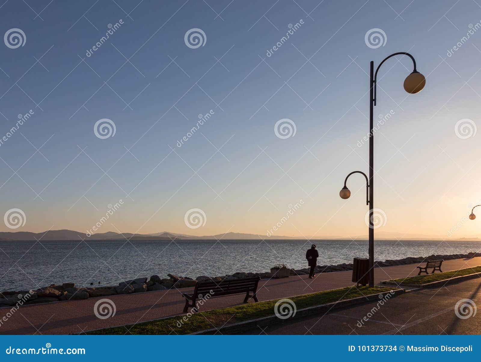 Old Man Walking Alone Near a Lake at Sunset Stock Photo - Image of ...