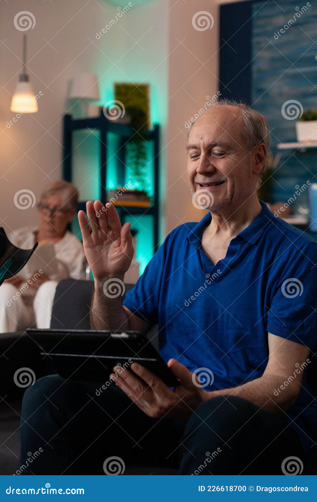 Old Man Waving at Video Call Webcam on Tablet Device Stock Photo ...