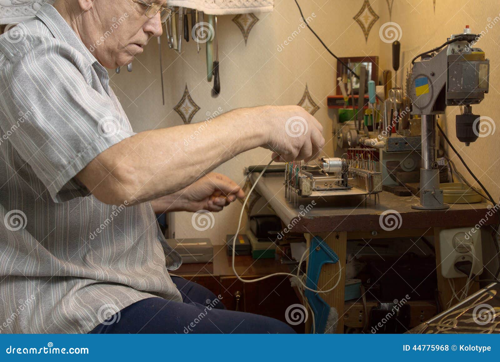 Old Man Working Electronic Device on Small Table Stock Photo - Image of ...