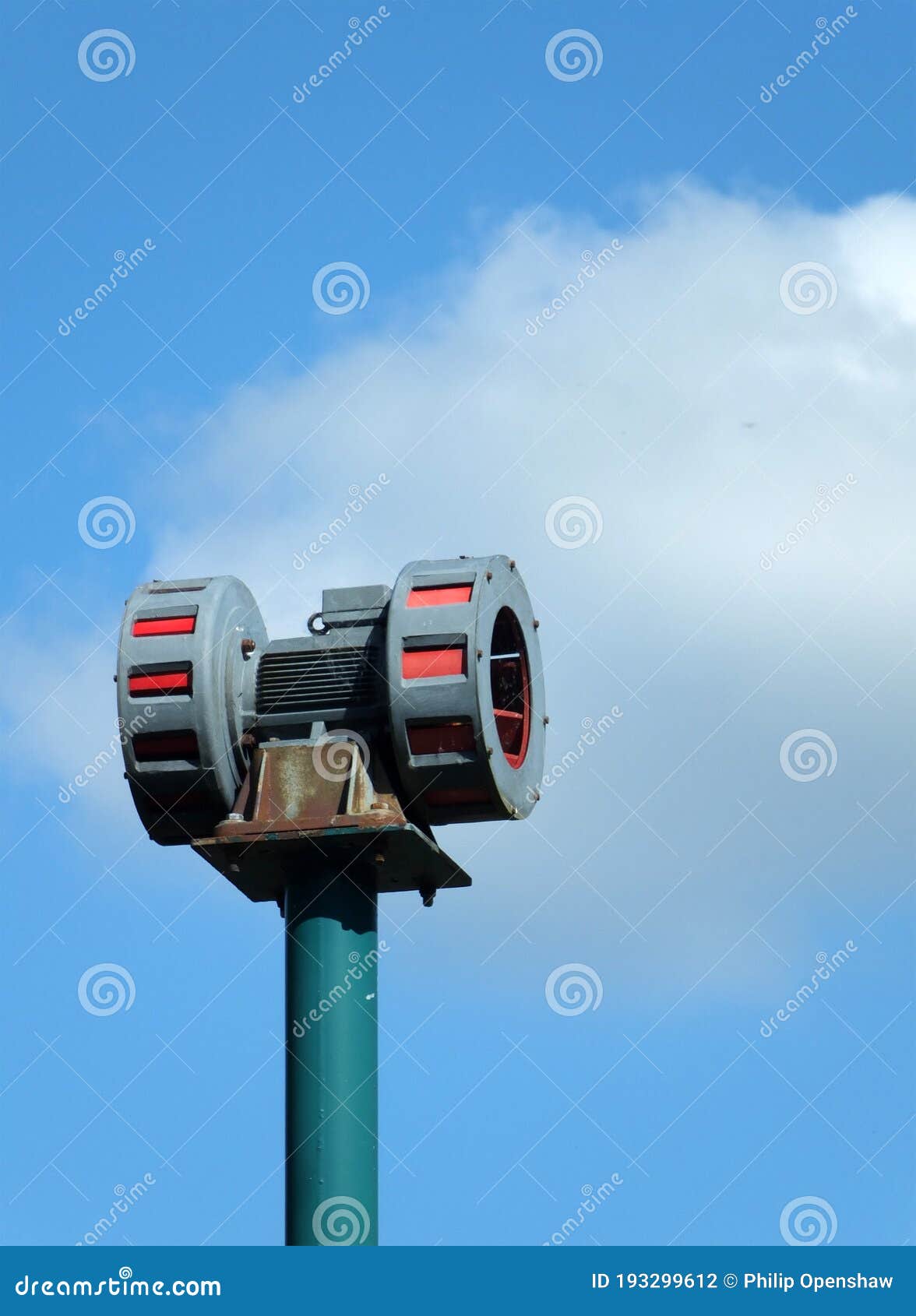 Old Mechanical Warning Siren on a Pole Against a Blue Cloudy Sky Stock ...