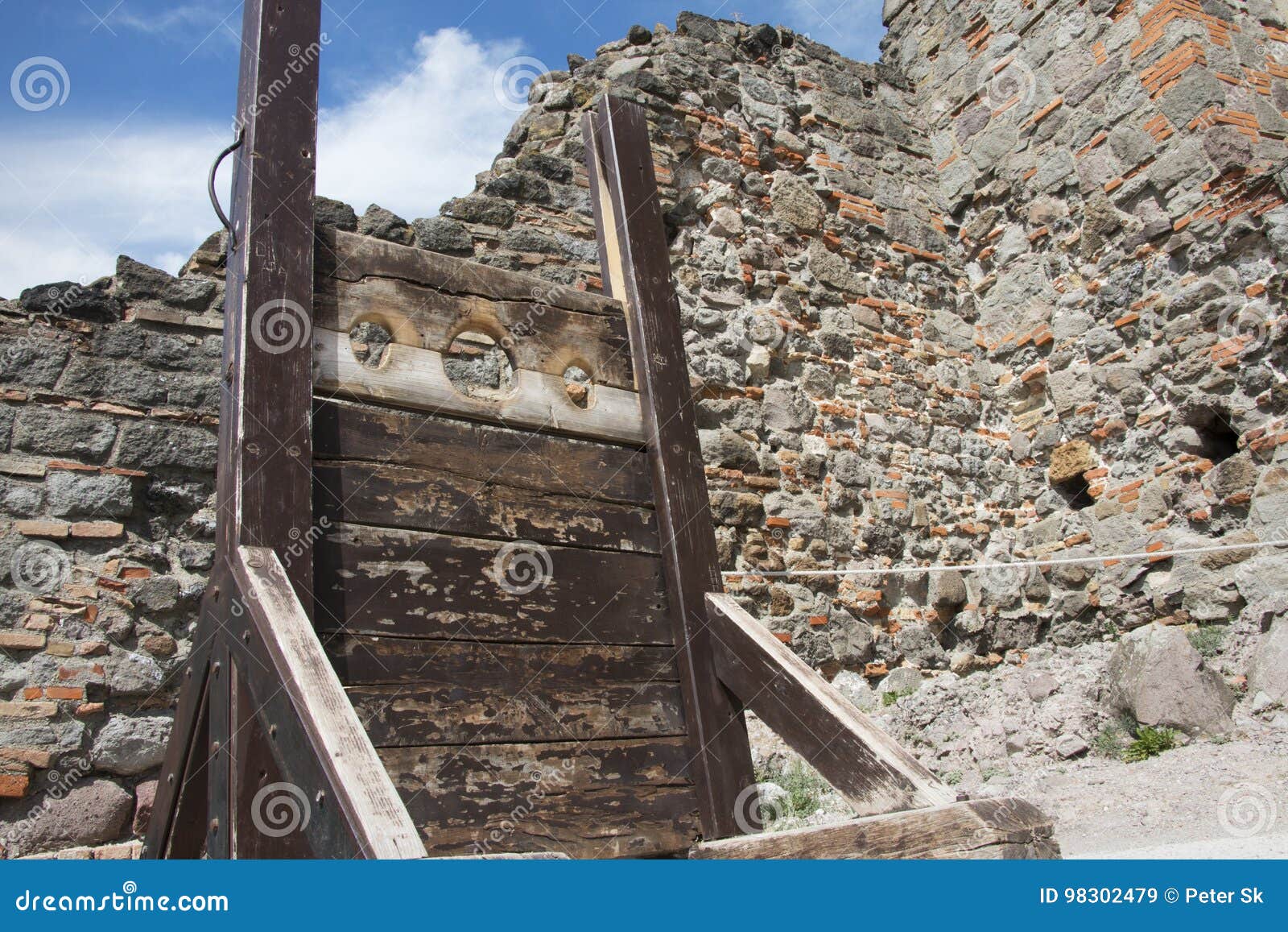 Wooden Stocks And Old, Ruined Trim Castle From 12th Century In The ...