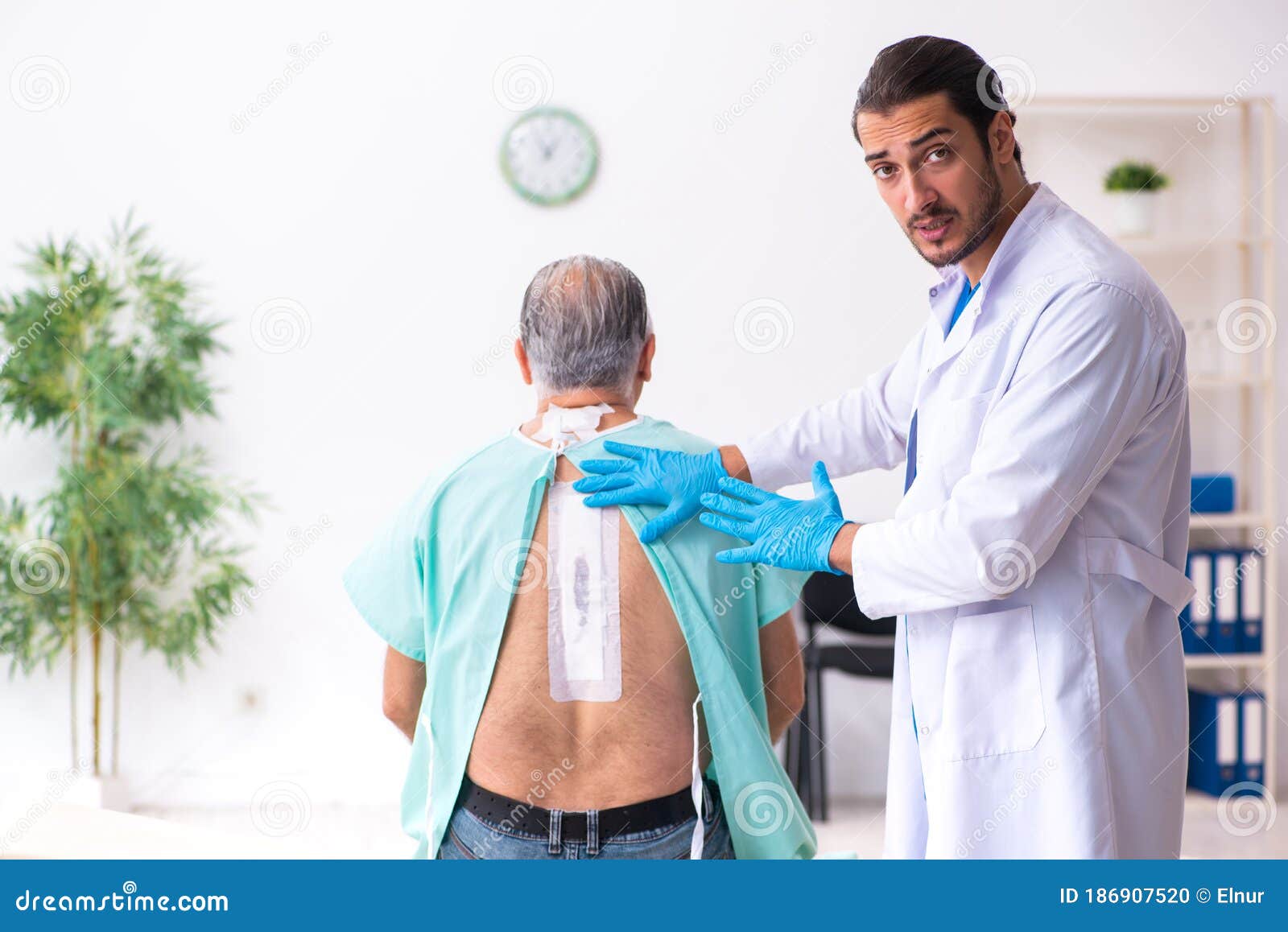 Old Man Visiting Young Male Doctor Stock Photo - Image of capsicum ...