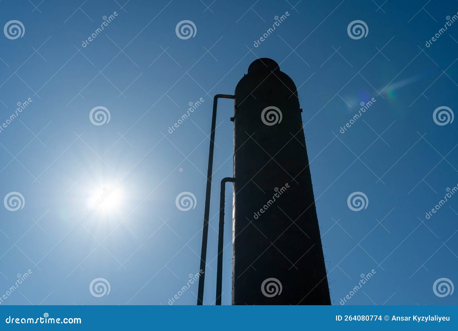 An Old Metal Rusty Water Tower Against the Background of the Blue Sky ...