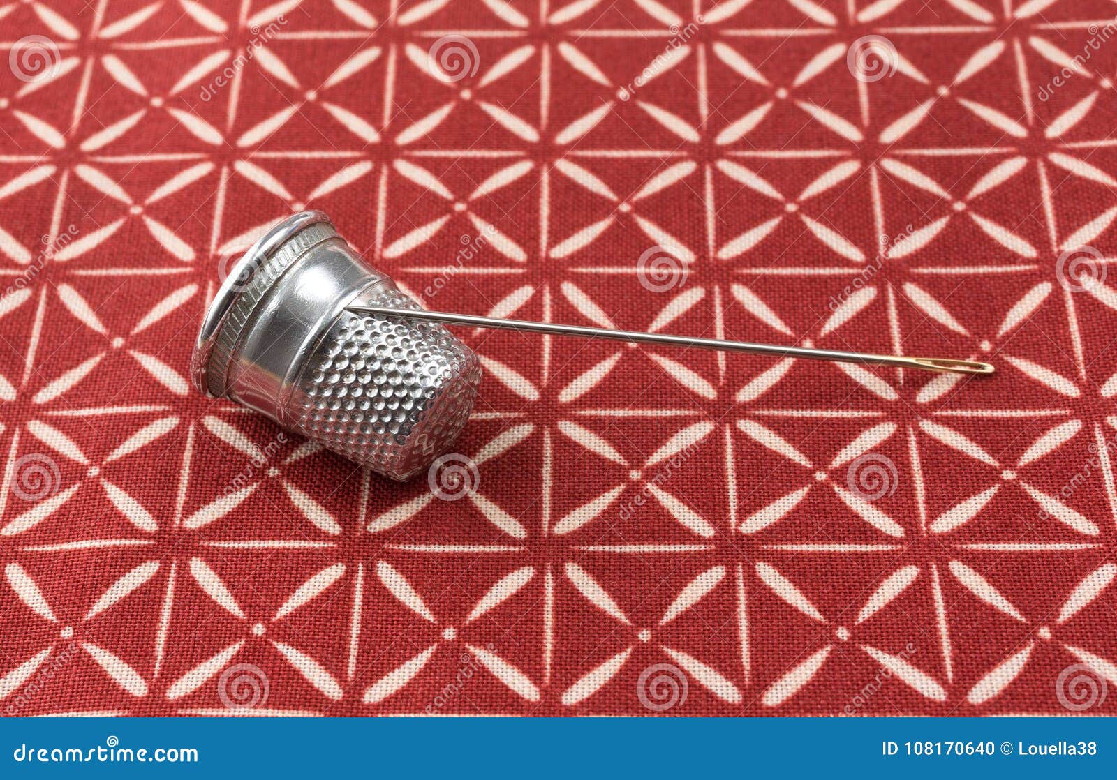 Old Sewing Thimble and Needle on a Piece of Fabric Stock Photo - Image ...