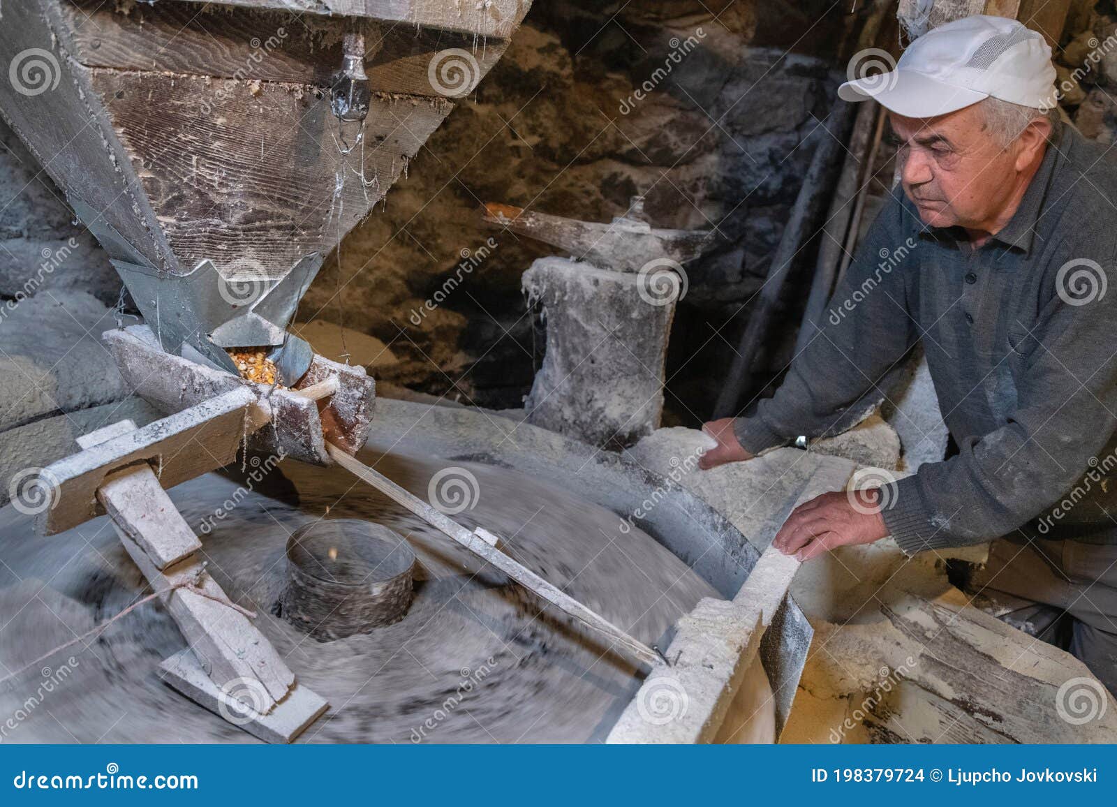 Old Mill for Grinding Grain Up Close. the Miller Grinds Grain Stock ...