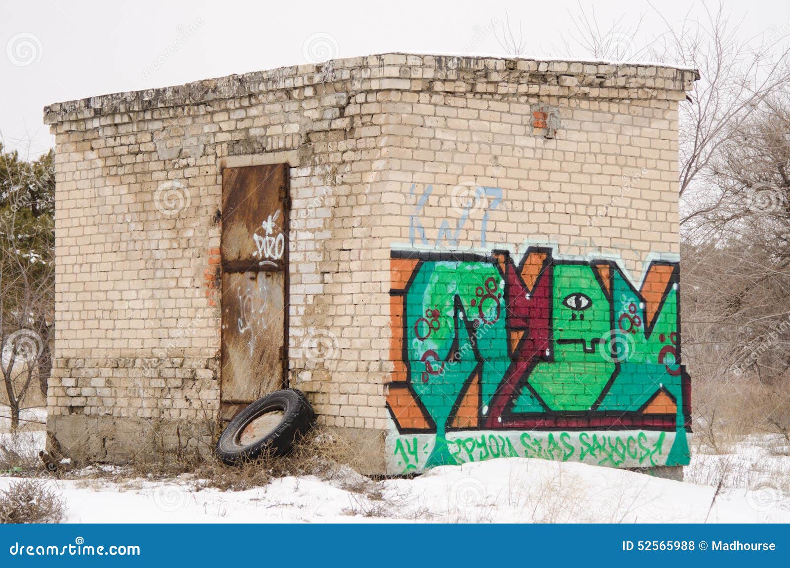 Old One-story Brick Building a Rusty Door with Graffiti on Wall ...