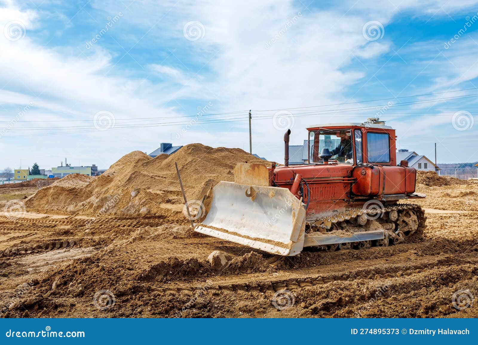 An Old Orange Bulldozer Performs Work To Level the Sandy Soil Stock ...