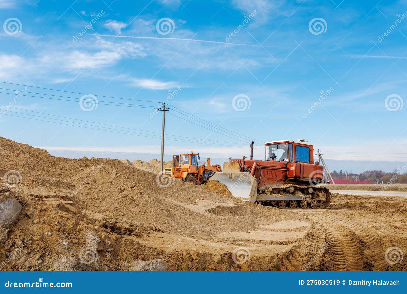 An Old Orange Bulldozer Performs Work To Level the Sandy Soil Stock ...
