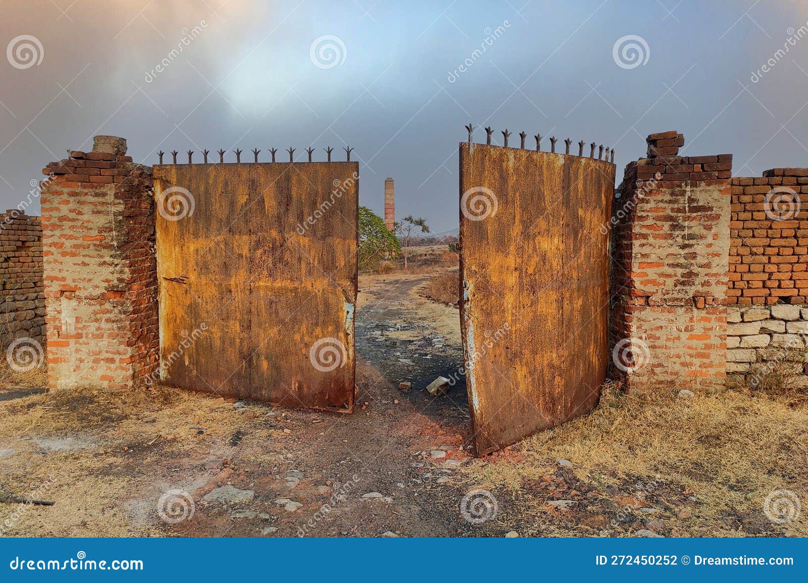 The Old Outer Wall and Broken Iron Gate of an Abandoned Factory Stock ...
