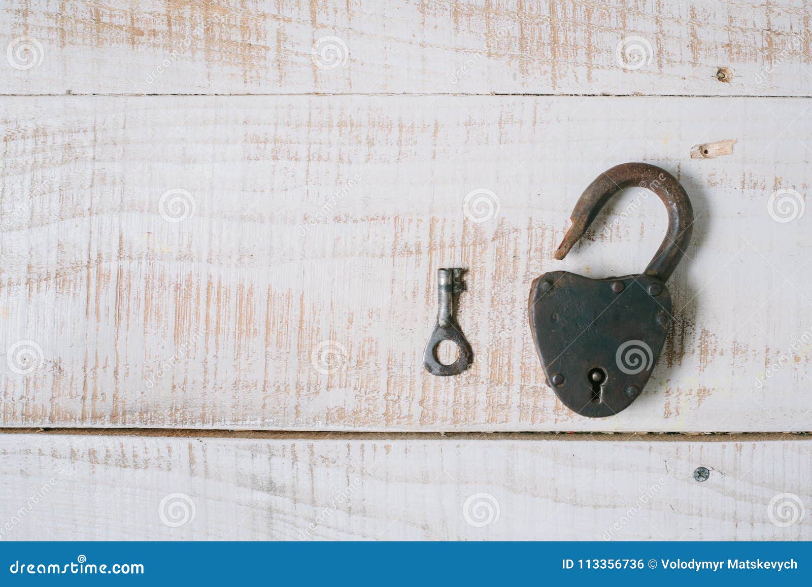 The Old Padlock and Key on a White Wooden Background. Top View Stock ...