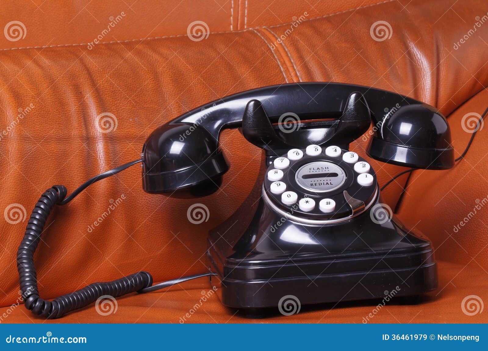Old phone on leather sofa stock image. Image of electronics - 36461979