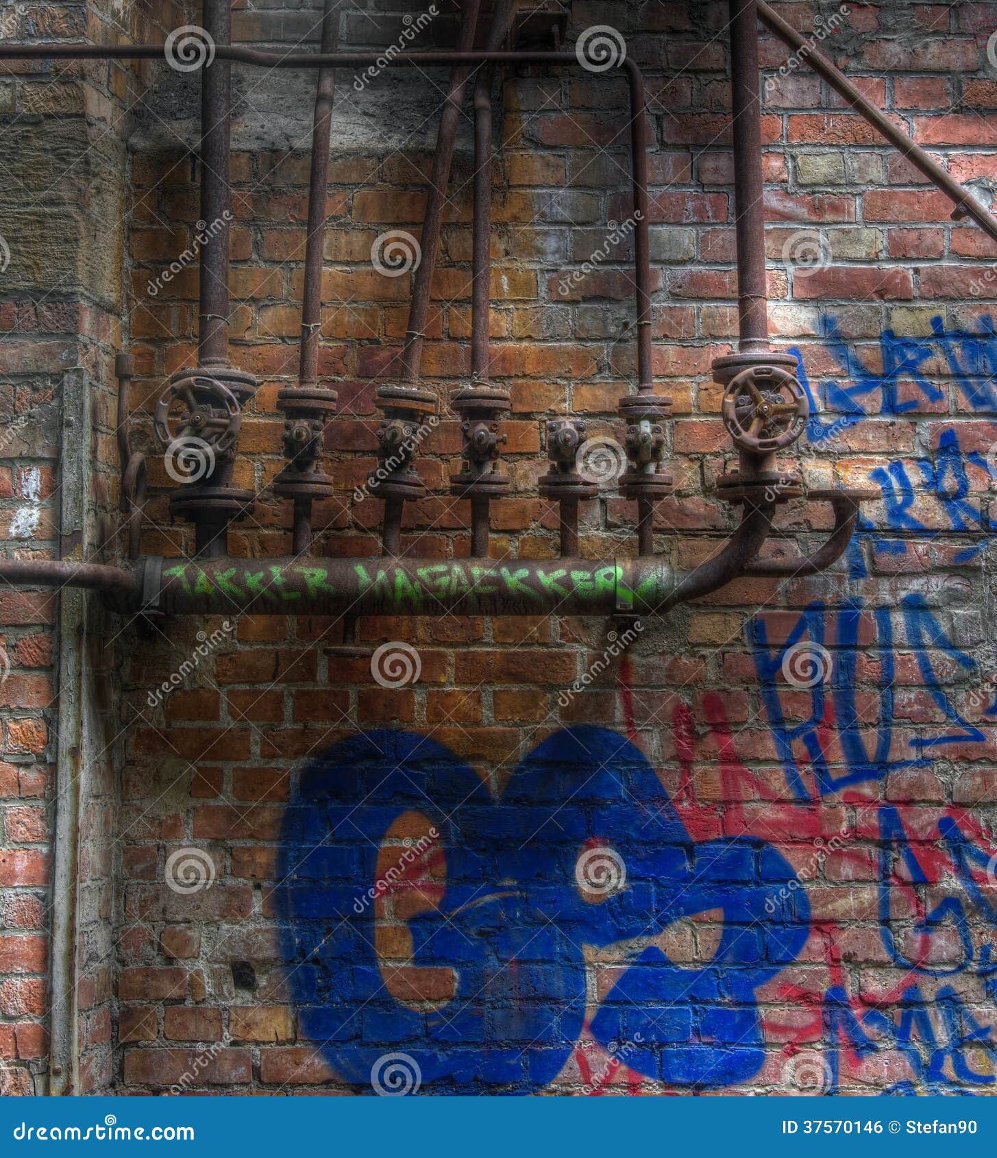 Old Pipes with Valves on a Wall with Graffiti Stock Photo - Image of ...