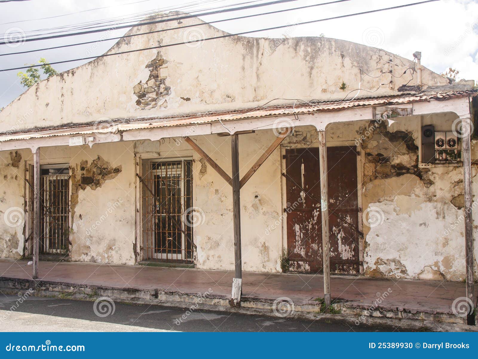 Old Plaster Building with Gated Doors Stock Photo - Image of bars ...