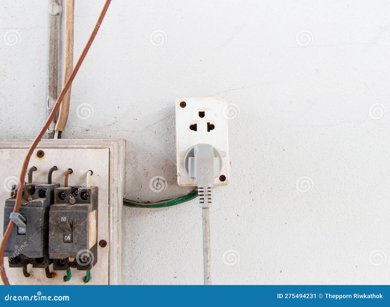 Old Plugging Electrical White Plug in Electric Socket on Wall Concrete ...