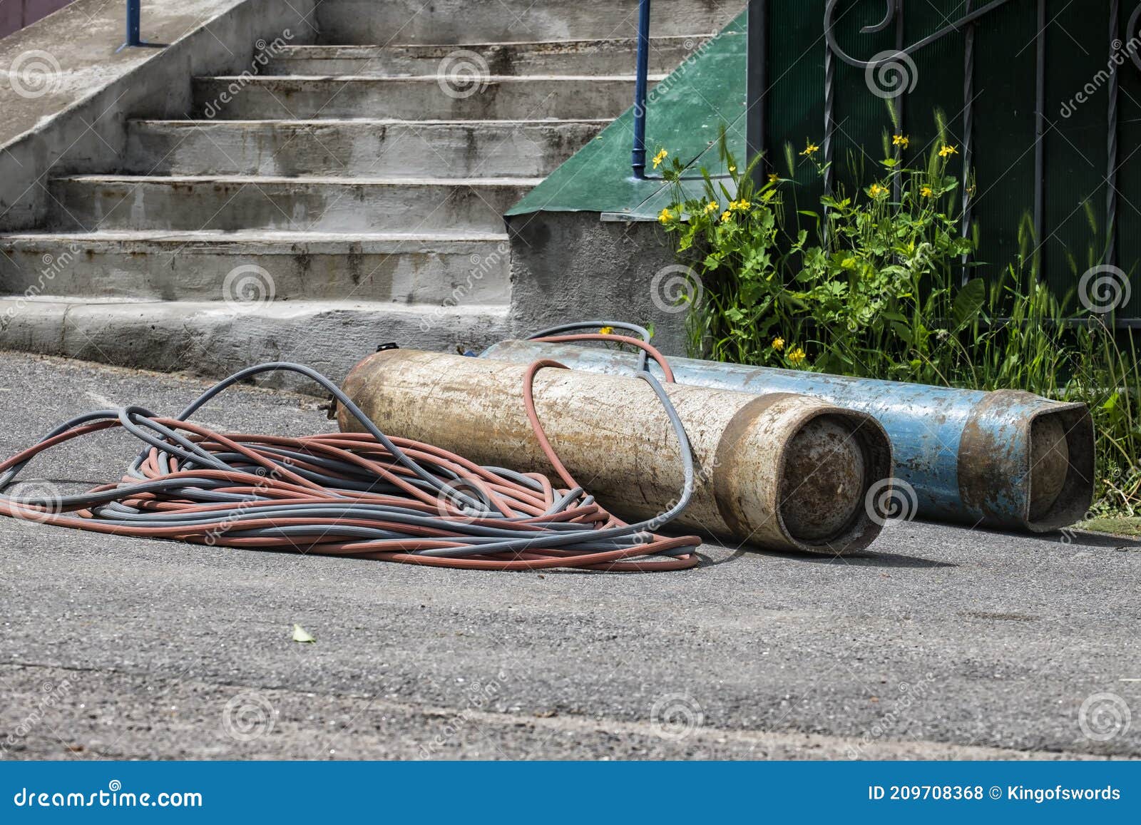 Old Propane and Oxygen Cylinders for Gas Welding Lie on the Ground ...