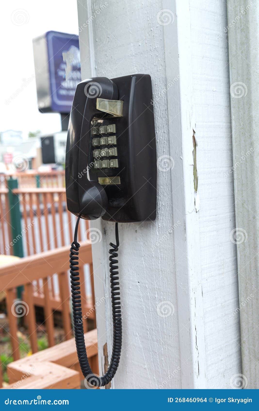 An Old Push-button Telephone Hangs on a White Wall on the Wall Stock ...