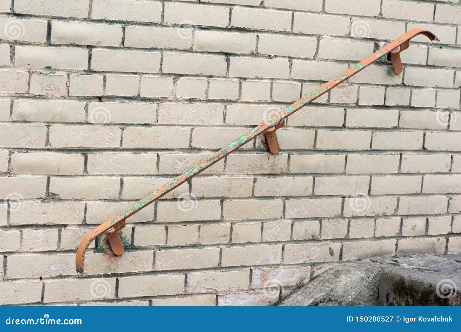 Old railing on brick wall stock image. Image of masonry - 150200527