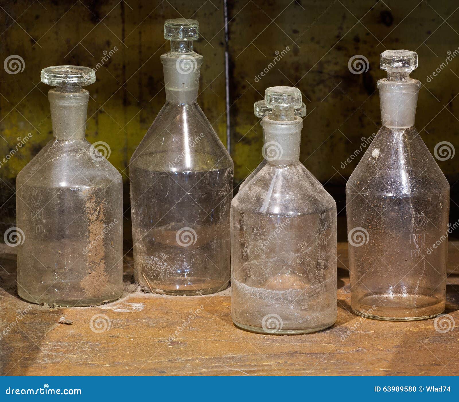 The Old Reagent Glass Bottles On Dusty Table Stock Photo ...