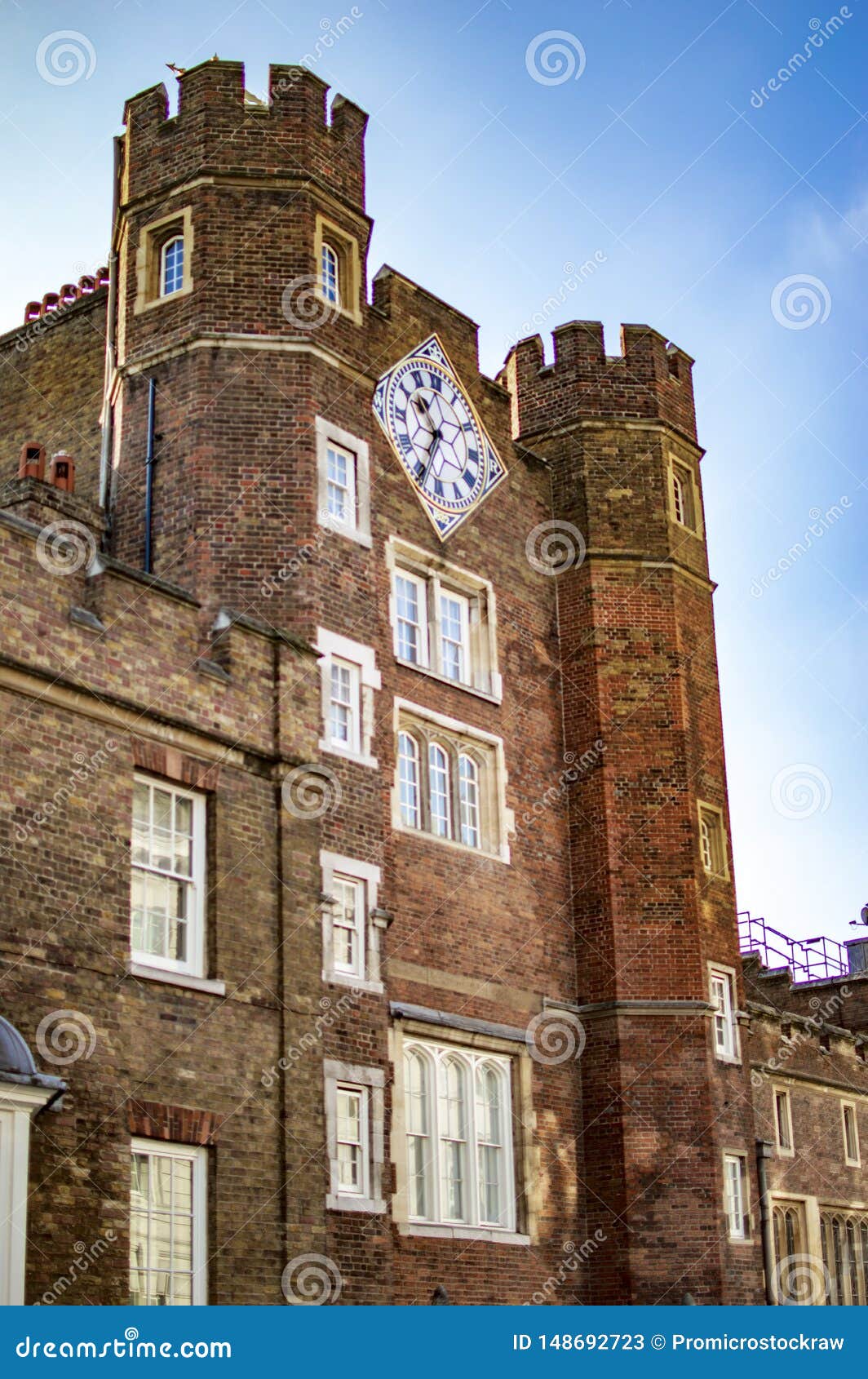 An Old Red Brick Building with a Clock Tower and Round Columns Stock ...