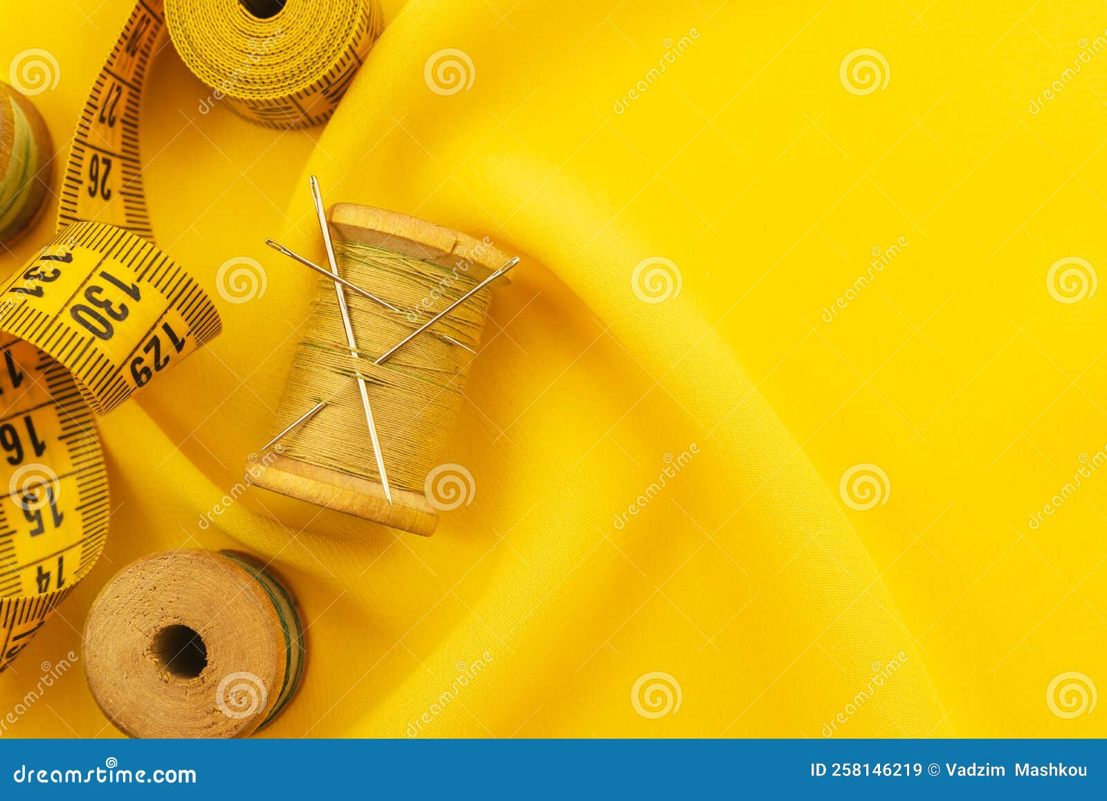 Old Retro Sewing Accessories Lie on a Yellow Fabric. Needle and Thread ...